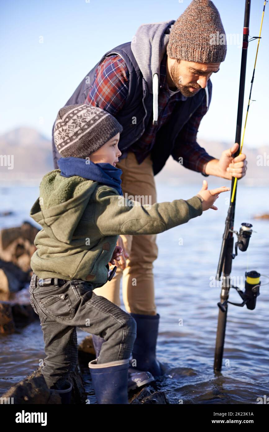 What did you see. a cute little boy fishing with his father by the sea ...
