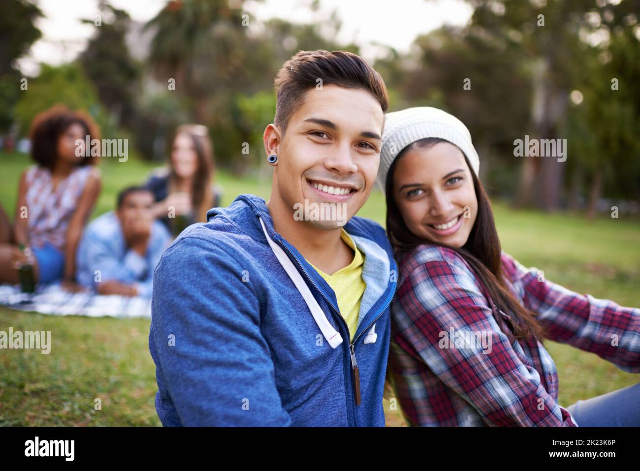 Getting close in the park. Portrait of a happy young couple at the park ...