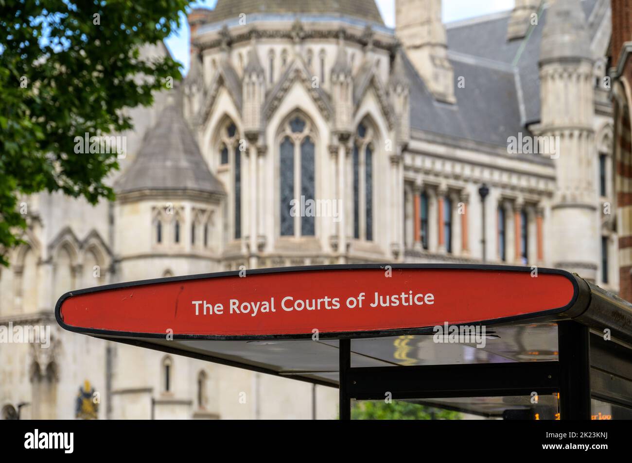 Royal Courts of Justice bus stop sign. Court buildings out of focus in ...
