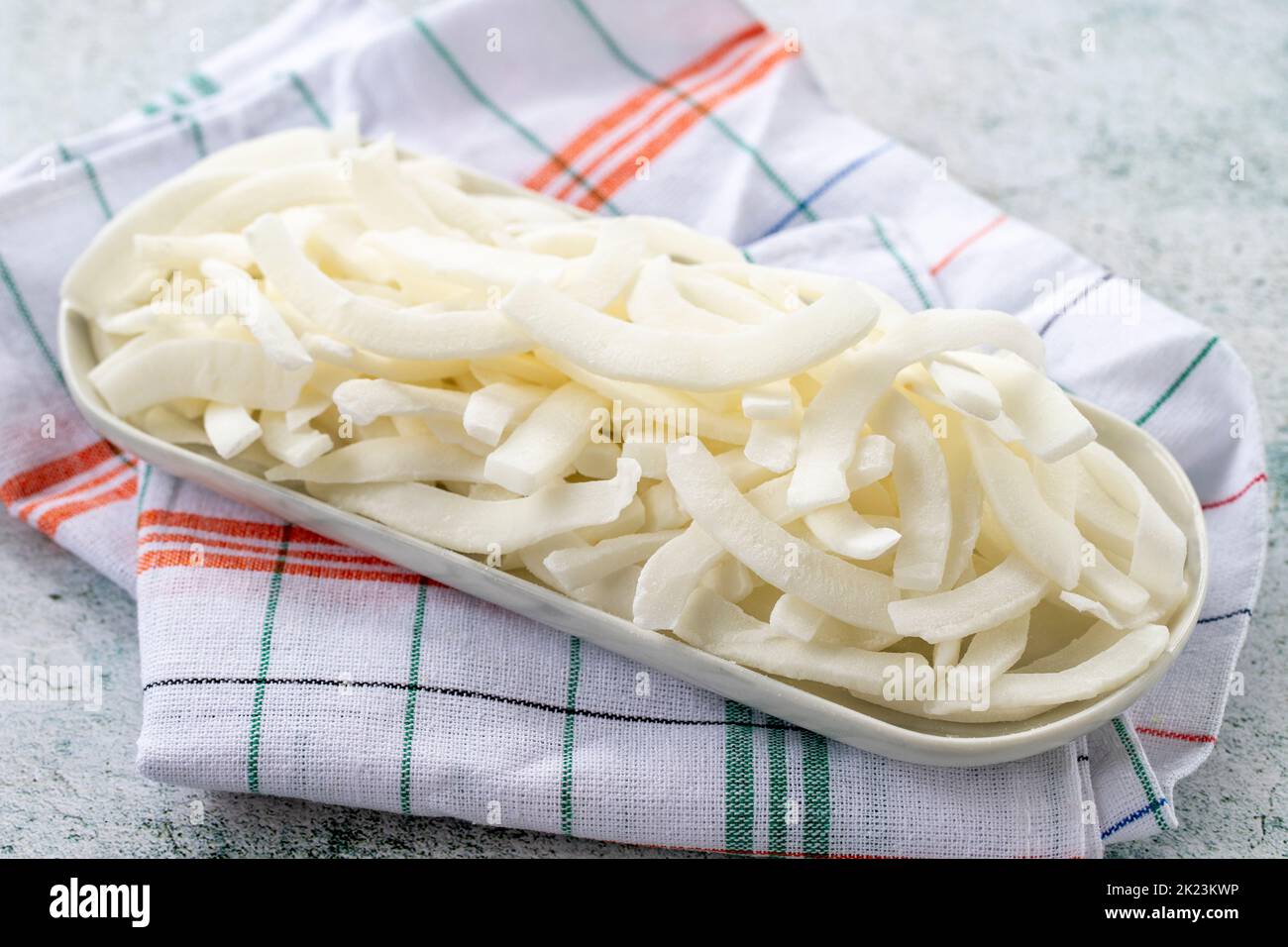 Dried coconut slice on gray background. Dried fruit in sunlight. close ...