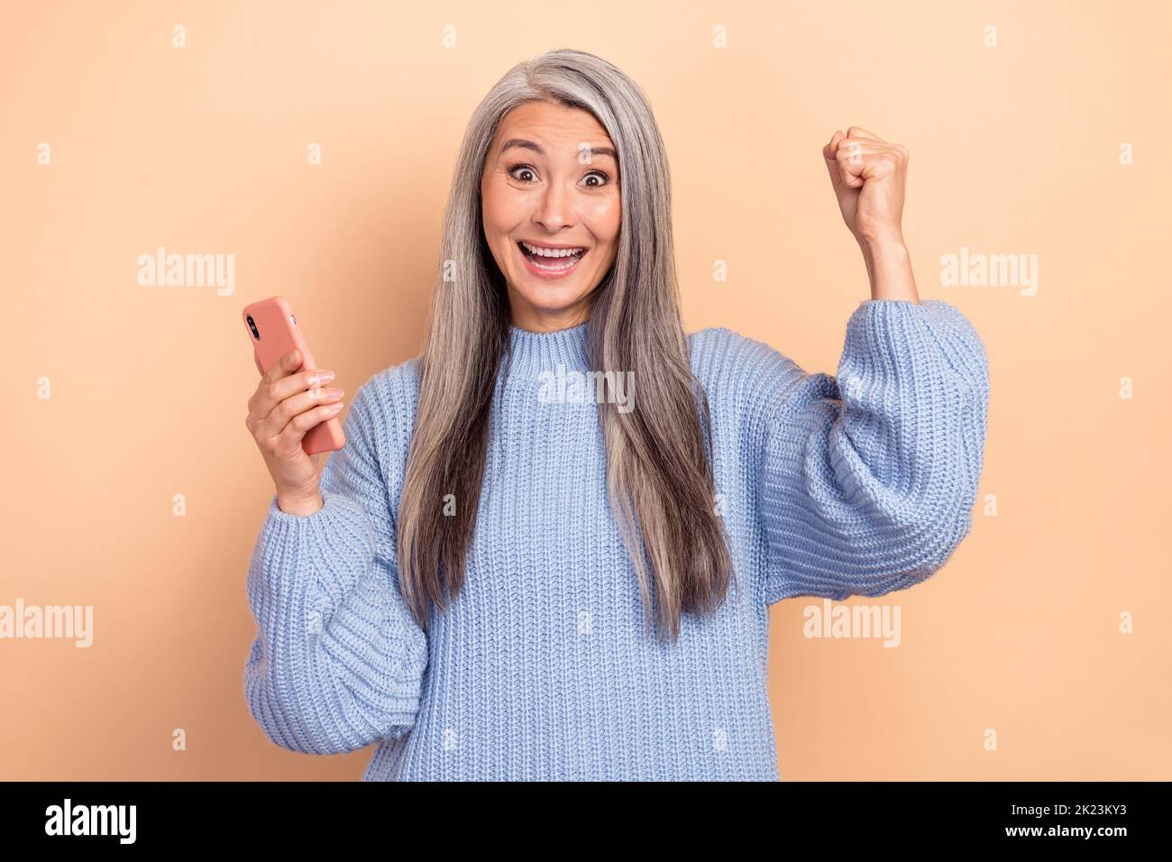 Photo of cheerful overjoyed funny woman raise fists in victory see big ...