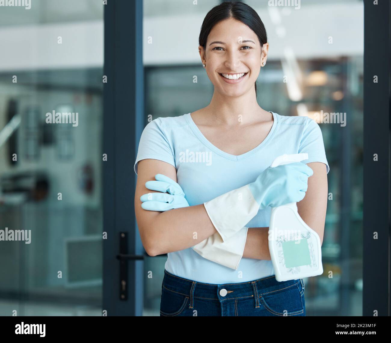 Portrait of a woman, cleaner or maid with gloves and detergent ready to ...
