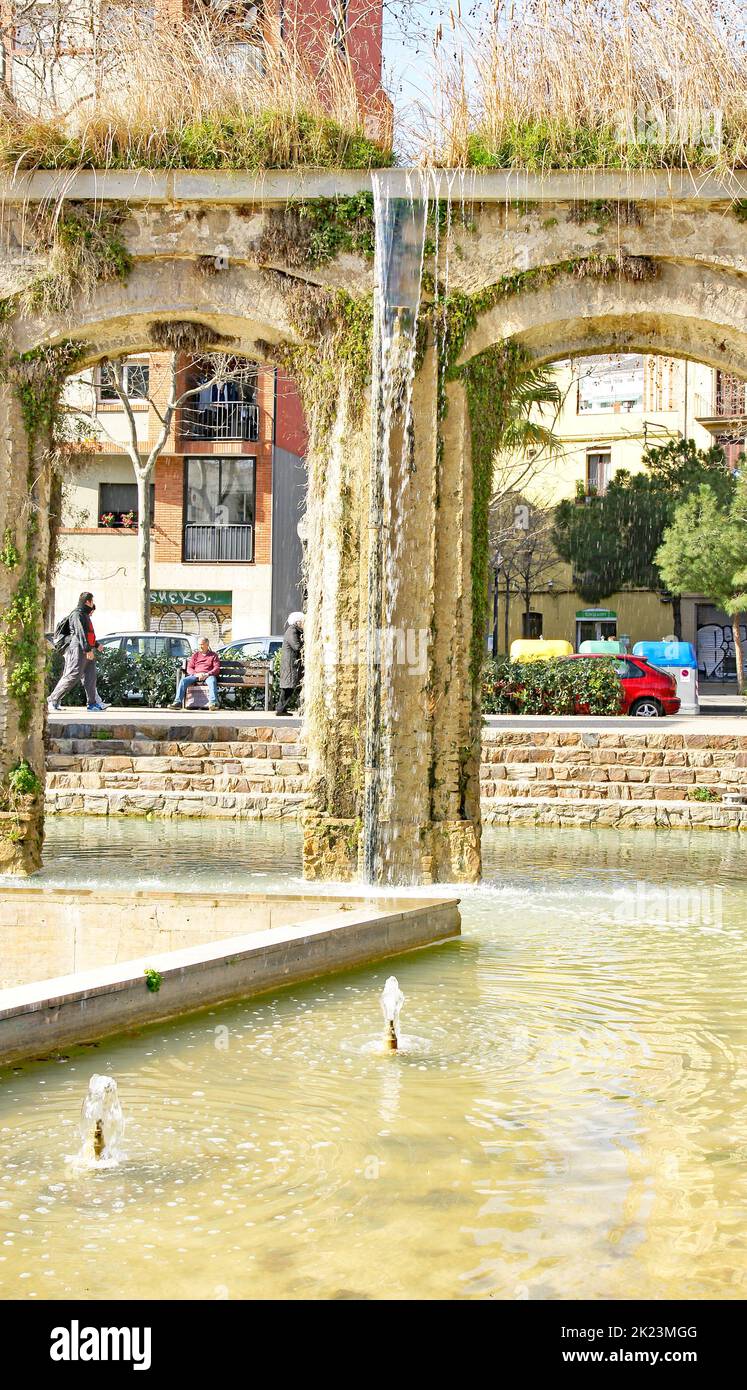 Arches and columns with fountain and pond in El Clot park, Barcelona ...