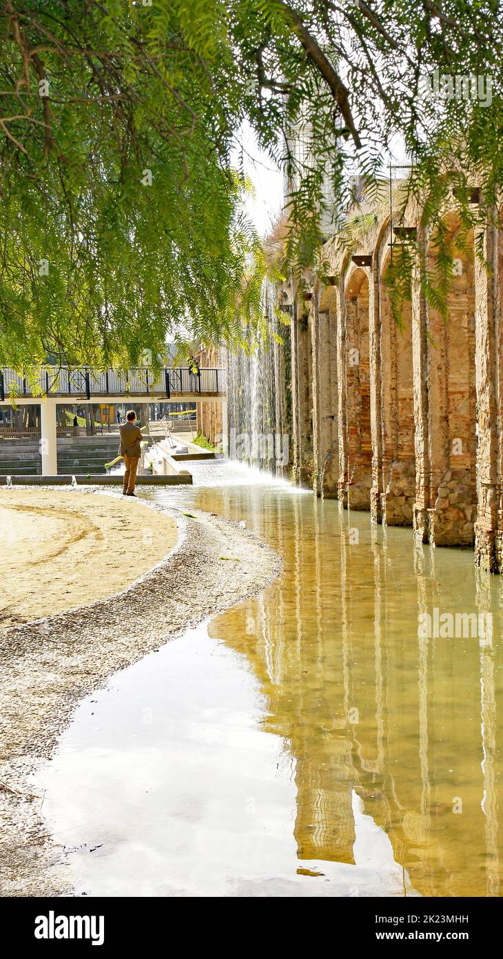 Arches and columns with fountain and pond in El Clot park, Barcelona ...