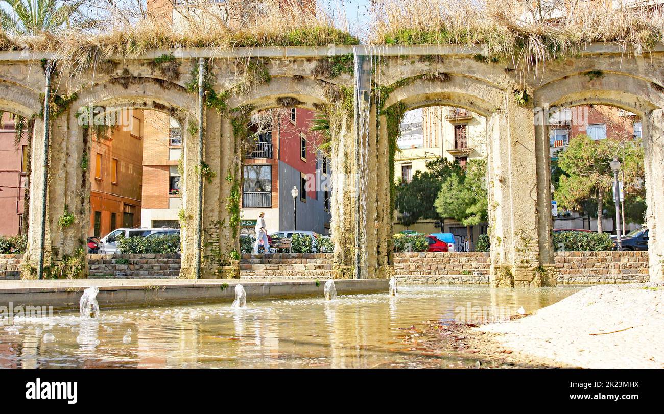 Arches and columns with fountain and pond in El Clot park, Barcelona ...