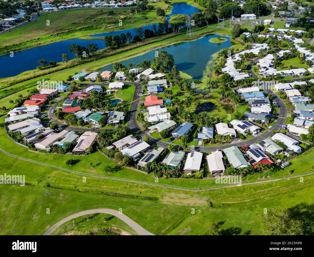 Aerial view of tropical housing estate with mountains and a lake Stock ...