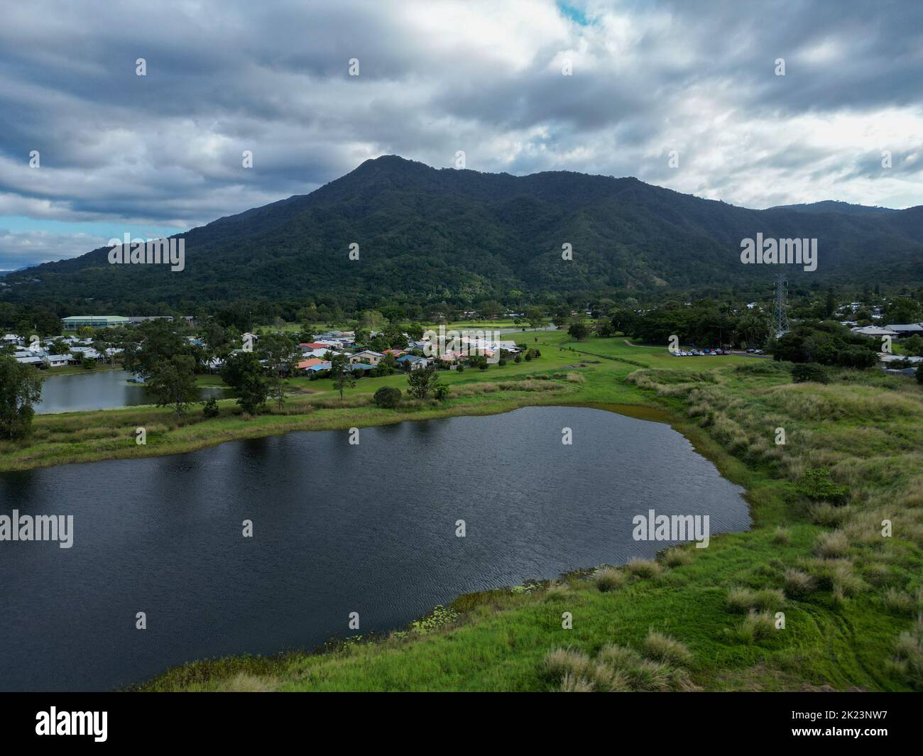 Aerial photo of lake with a mountain backdrop and clody sky Stock Photo ...