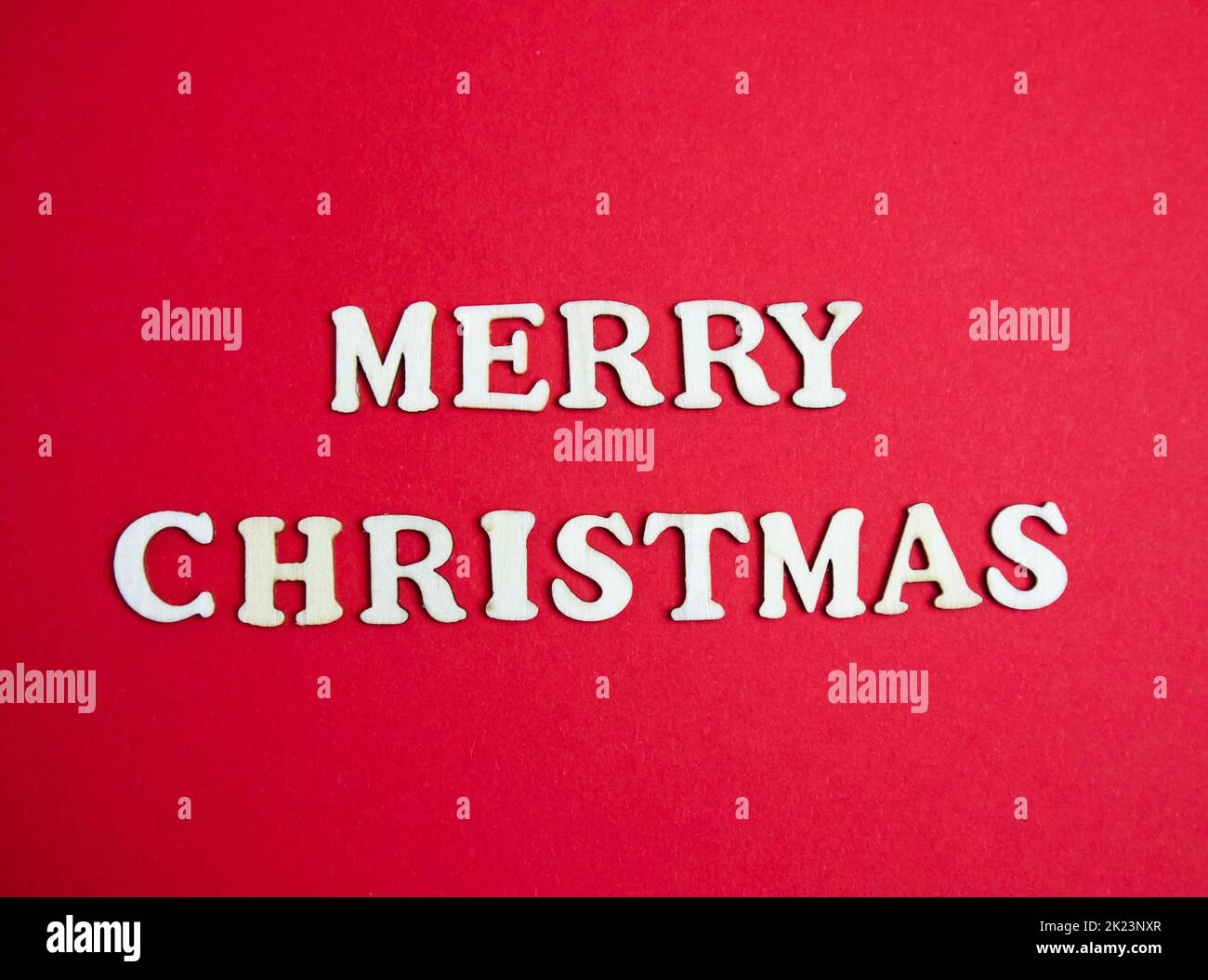 Merry christmas lettering with wooden letters on red background Stock ...