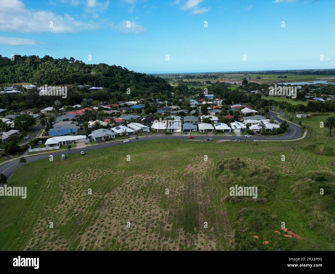 Aerial view of tropical housing estate with mountains and blue sky ...