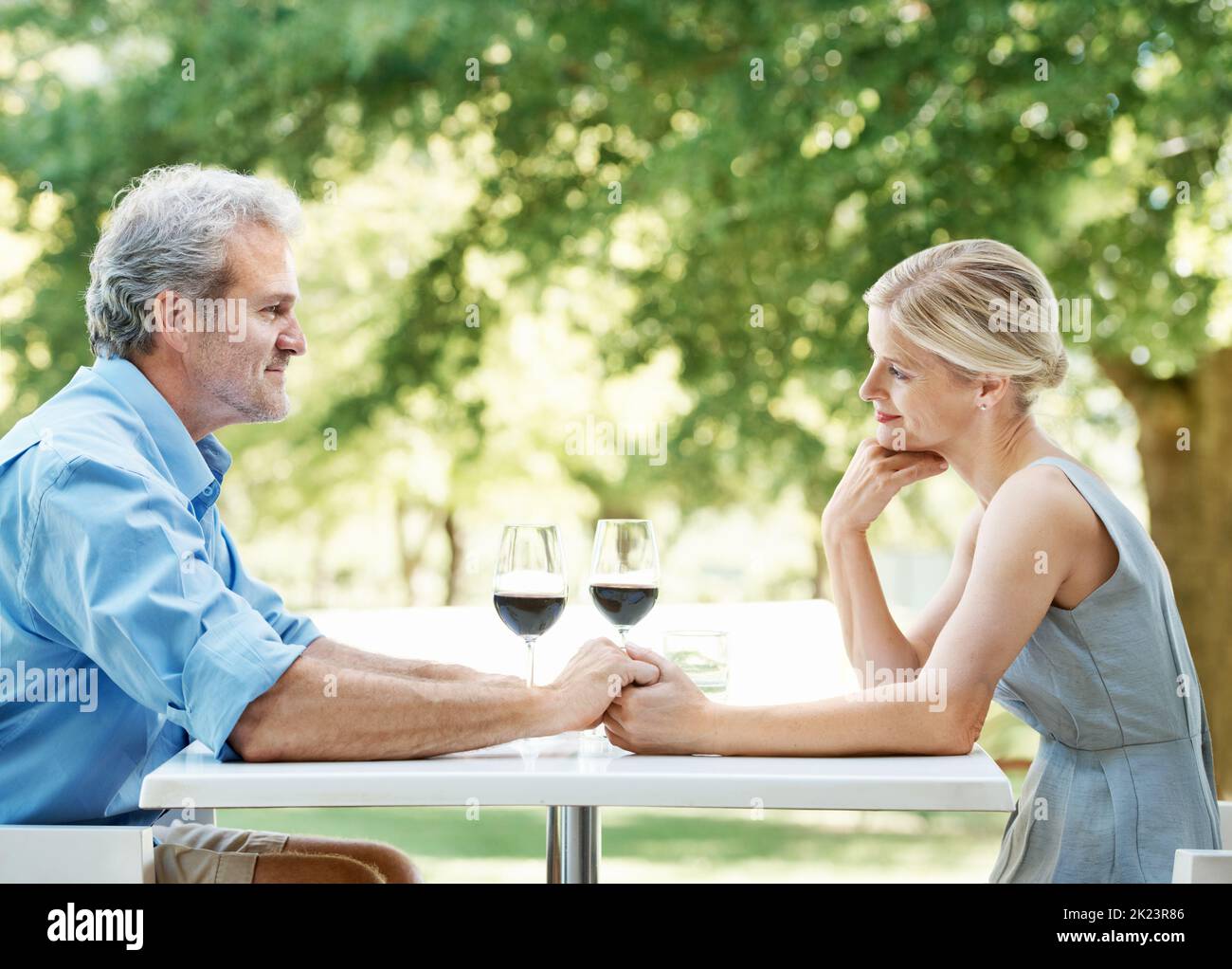 Bonding over their lunch date. Happy mature couple sitting at a table ...