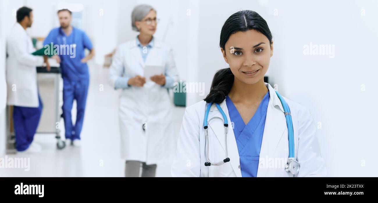 Asian female physician with stethoscope standing in front view of ...
