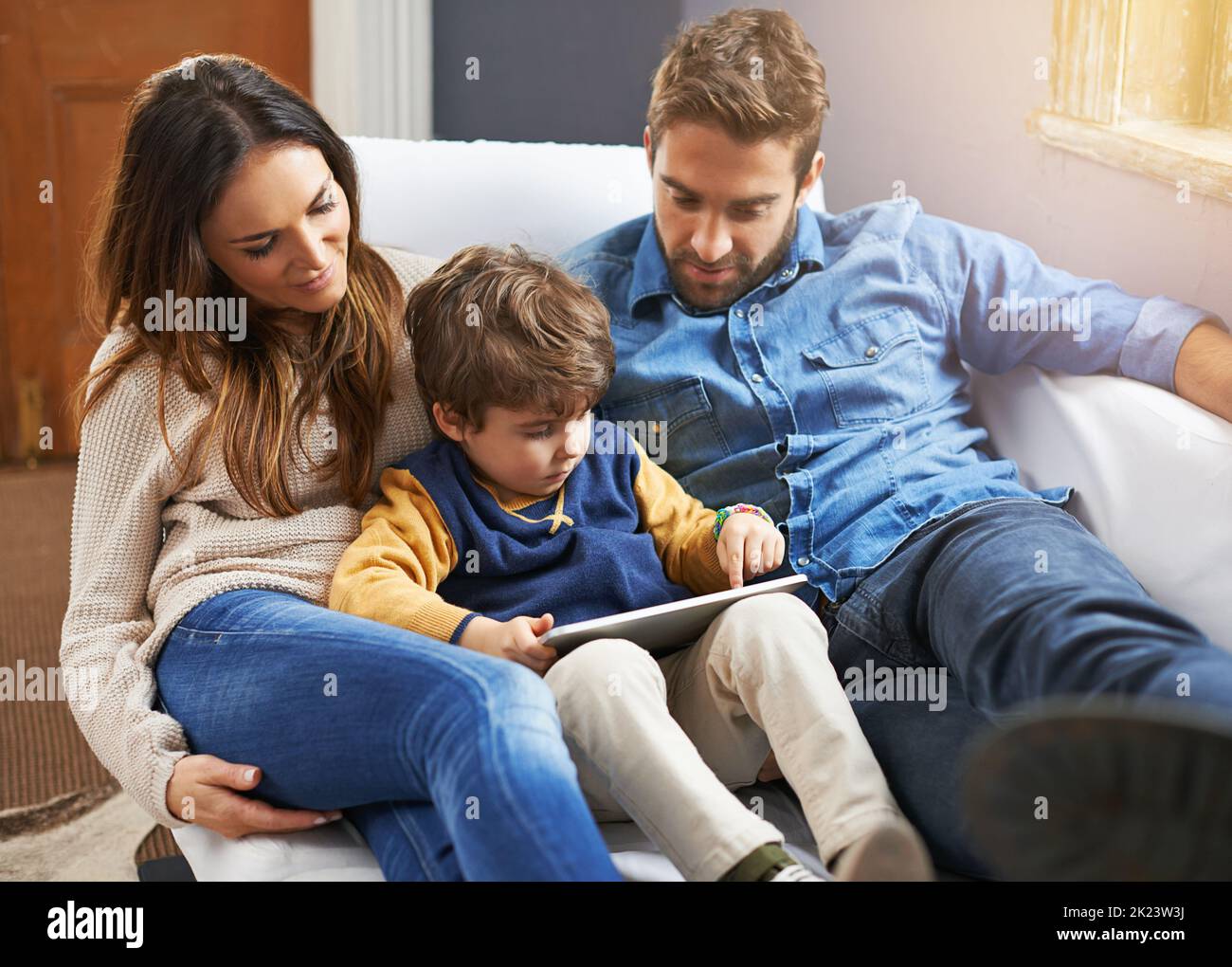 Showing his parents a thing or two. a loving family looking at a ...