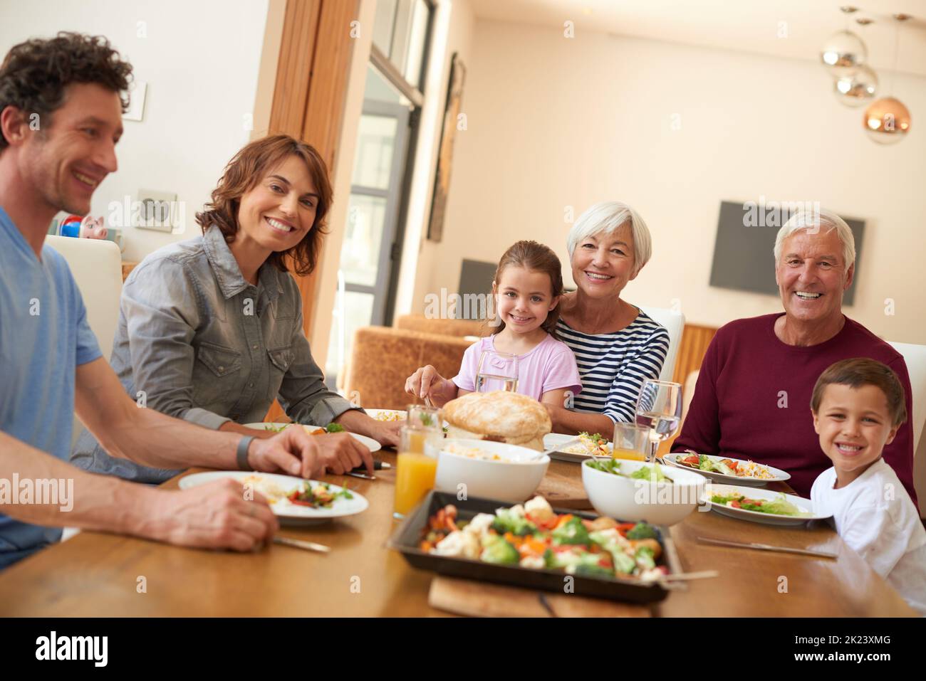 Lunch is served. a multi generational family having a meal together ...