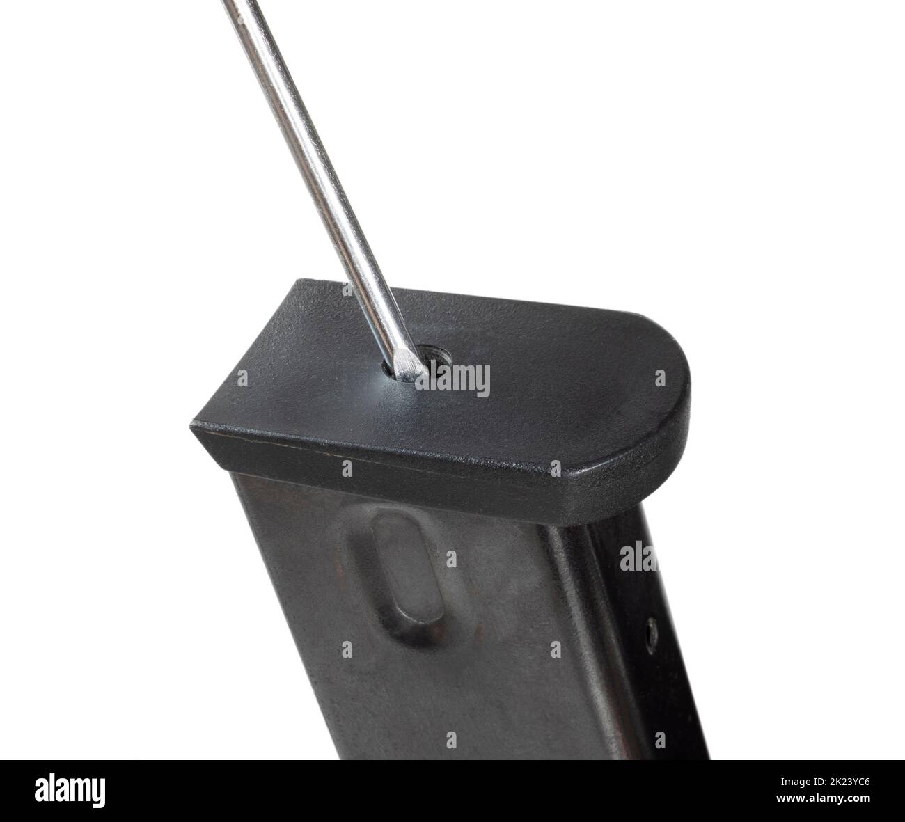 Button on a pistol magazine being depressed to release the base plate ...