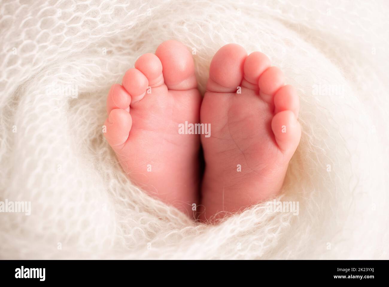 Soft feet of a newborn. Close-up of toes, heels and feet of a newborn ...
