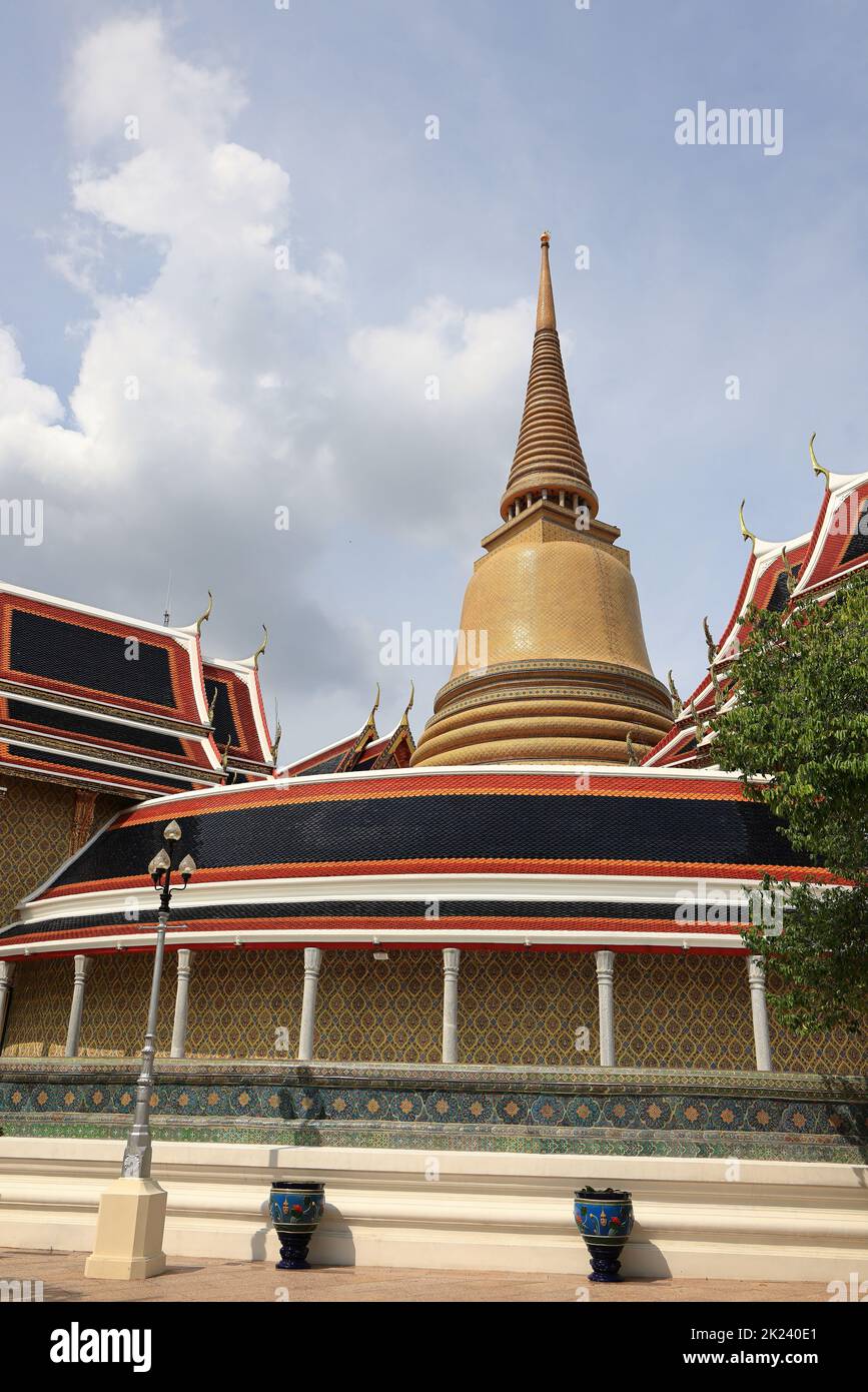 The big yellow ancient pagoda appear over the roof of Buddhist temple ...