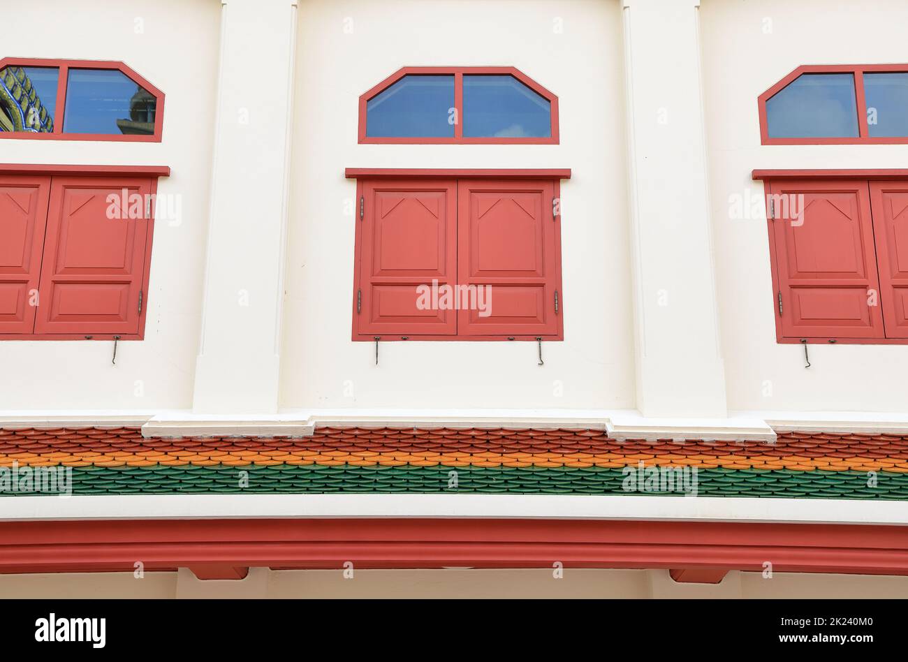 dusty white ancient building facade with with the small beautiful red ...