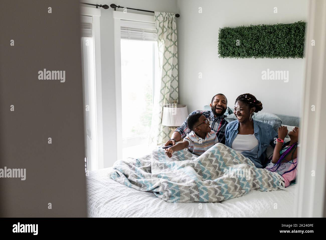 Family on the bed hi-res stock photography and images - Alamy