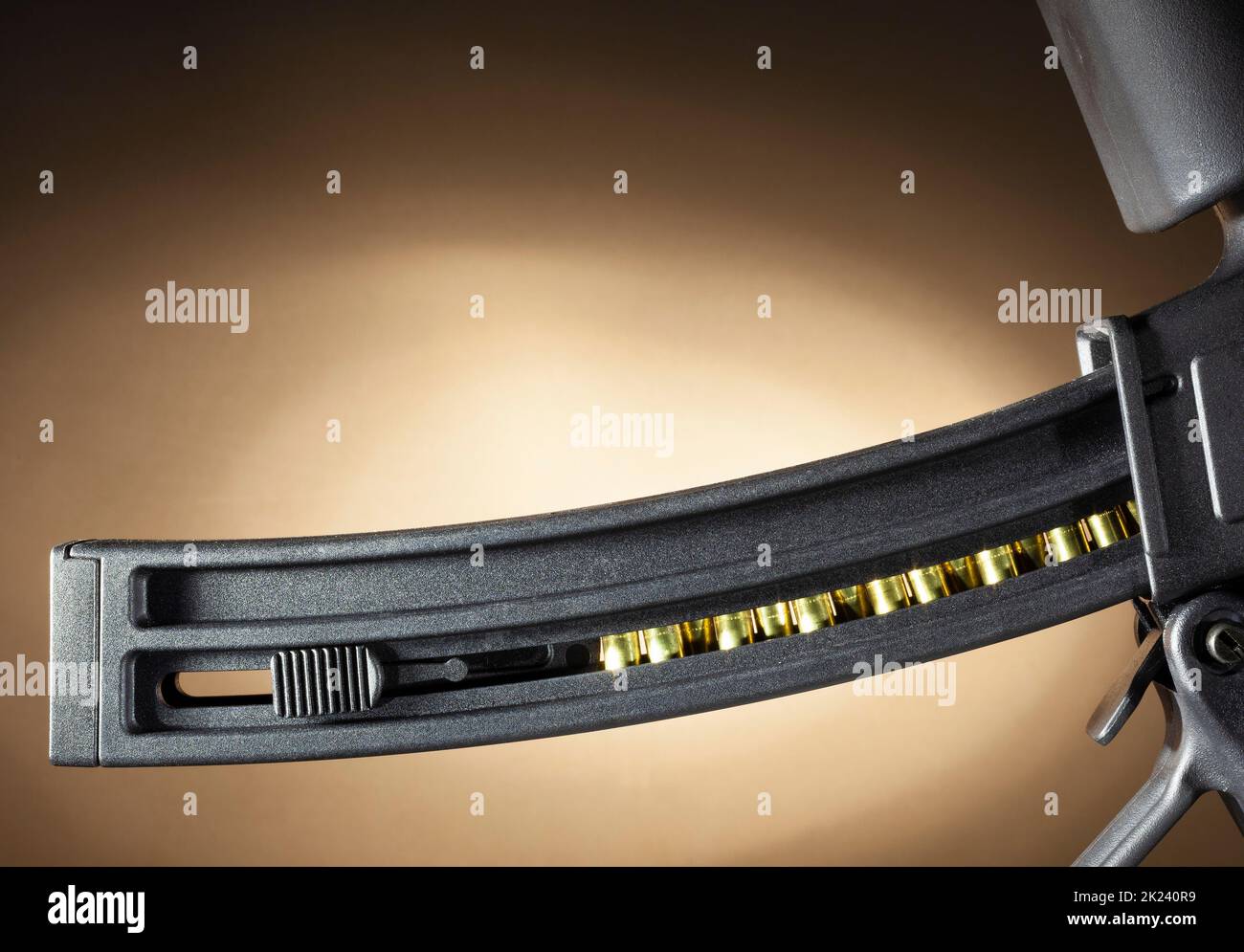 Rifle magazine loaded with rimfire cartridge on a brown background with ...