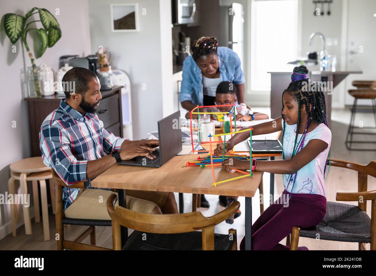 African american daughter doing homework table hi-res stock photography ...