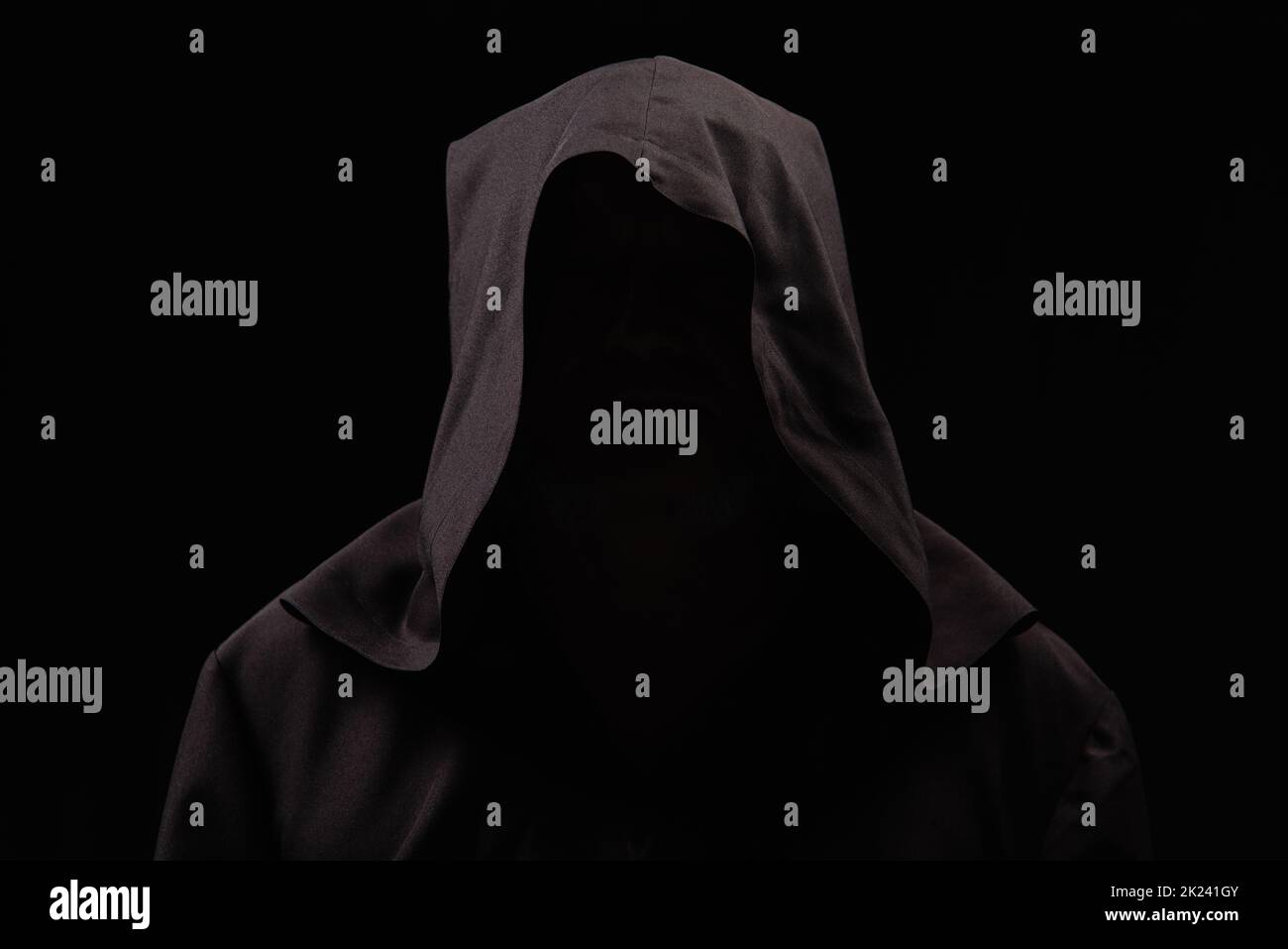 mysterious anonymous monk in dark hood isolated on black,stock image ...