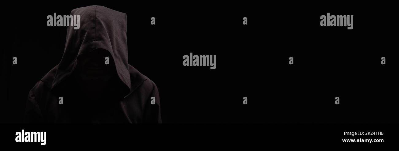 mysterious monk with face under hood isolated on black, banner,stock ...