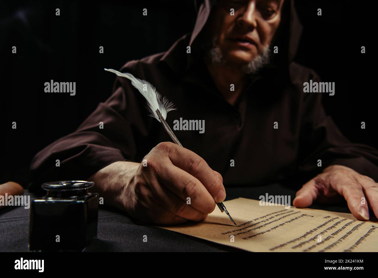 blurred medieval monk writing manuscript with feather pen isolated on ...