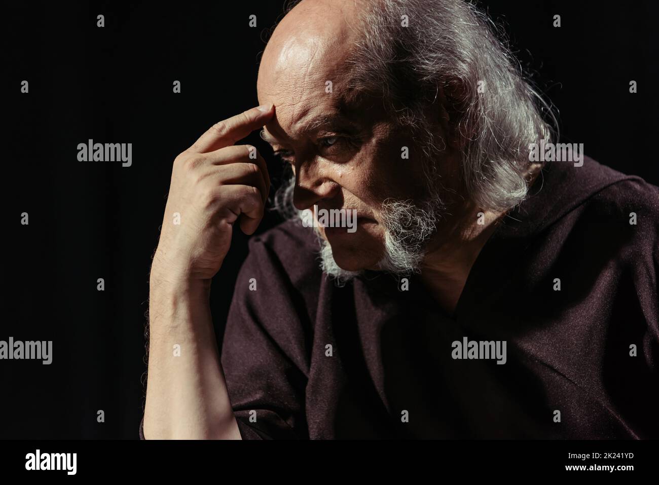 medieval religious philosopher touching forehead and thinking isolated ...