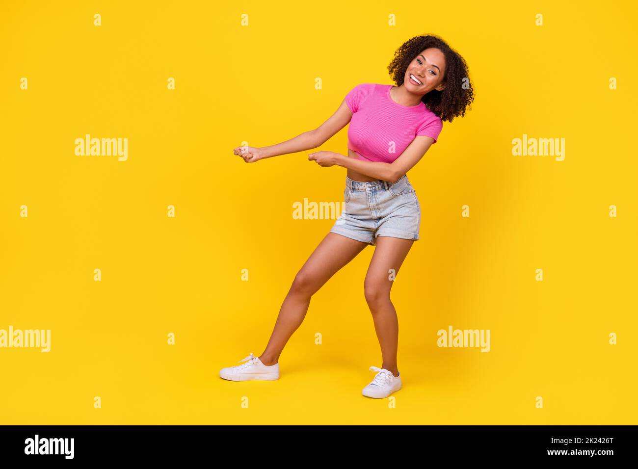 Full length profile photo of funky carefree girl hands pull empty space ...