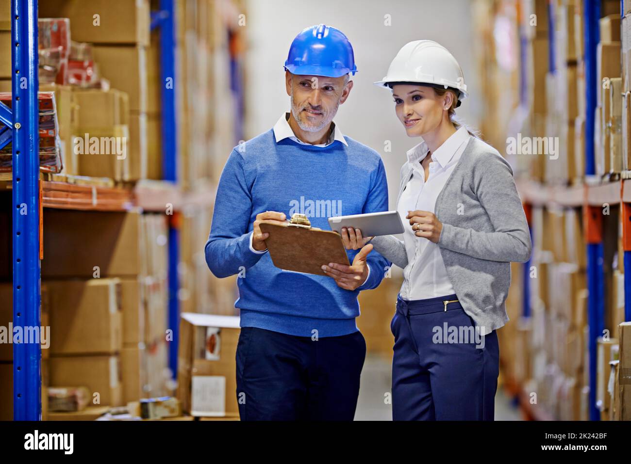 Tracing your order online and on paper. a man and woman inspecting ...