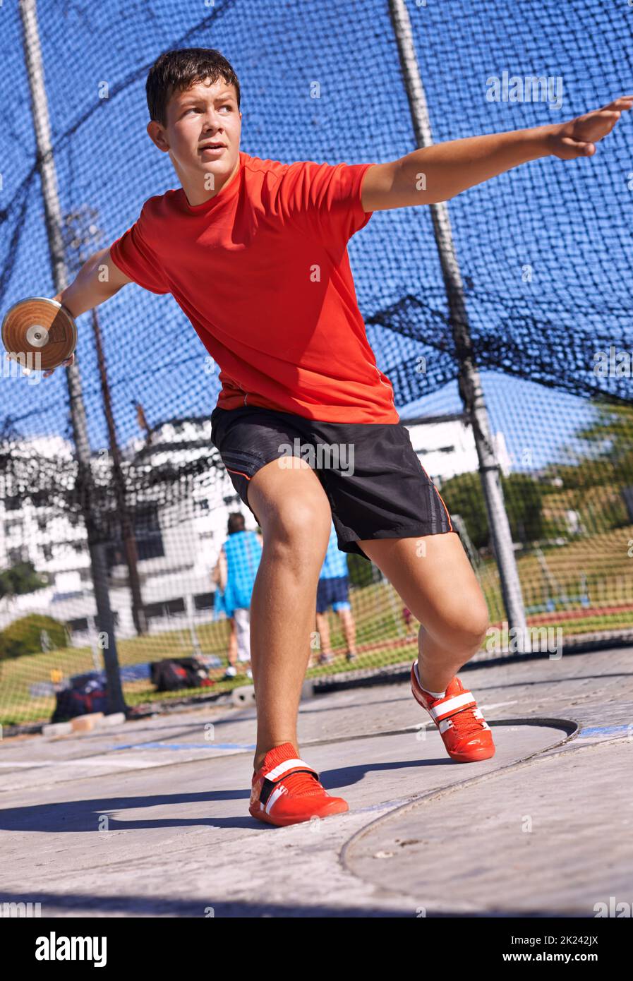 Going the distance. a young sportsman throwing a discus Stock Photo - Alamy