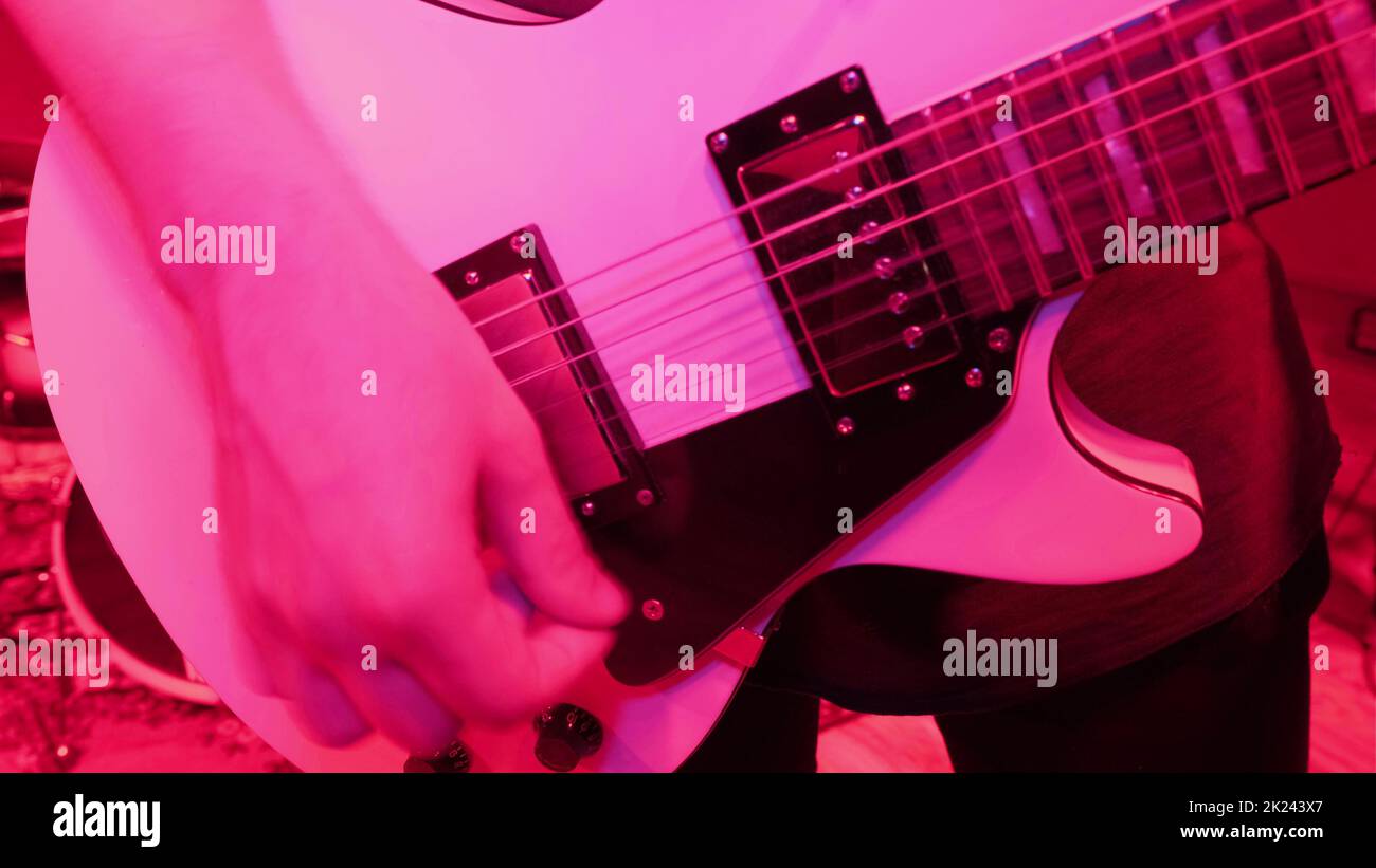 Repetition of rock music band. Cropped image of electric guitar player ...
