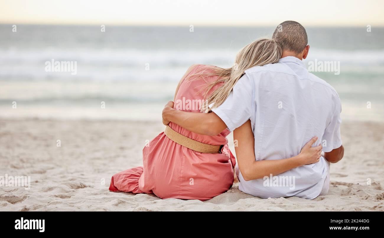 Happy, love and couple on a beach hug watching the sunset, beach waves ...