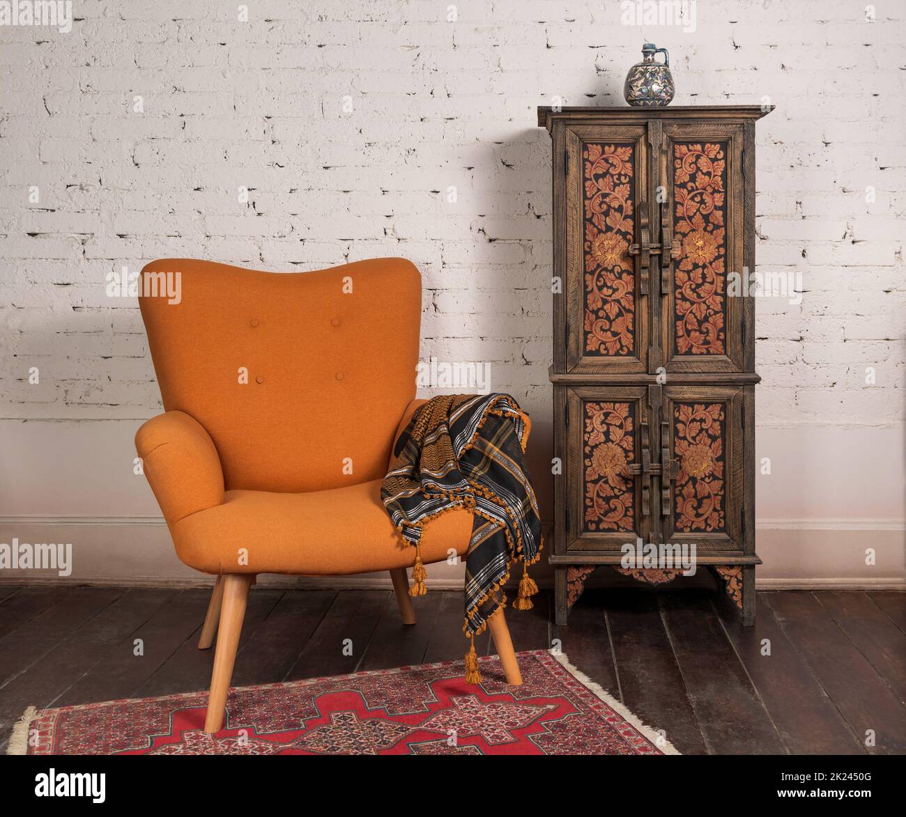 Living room corner with french orange wingback armchair, decorated ...