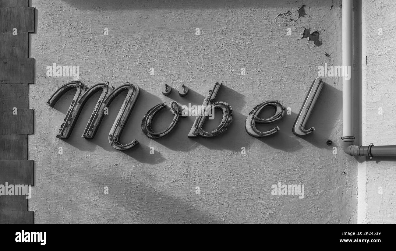 old rusted neon sign with the word furniture Stock Photo - Alamy