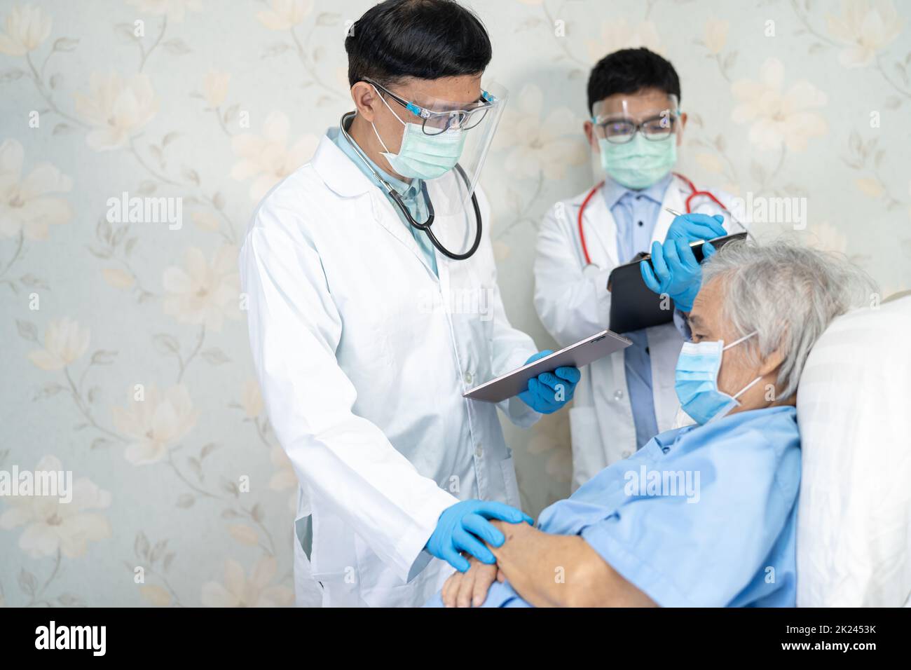 Asian doctor team check old senior lady patient for disease to ...