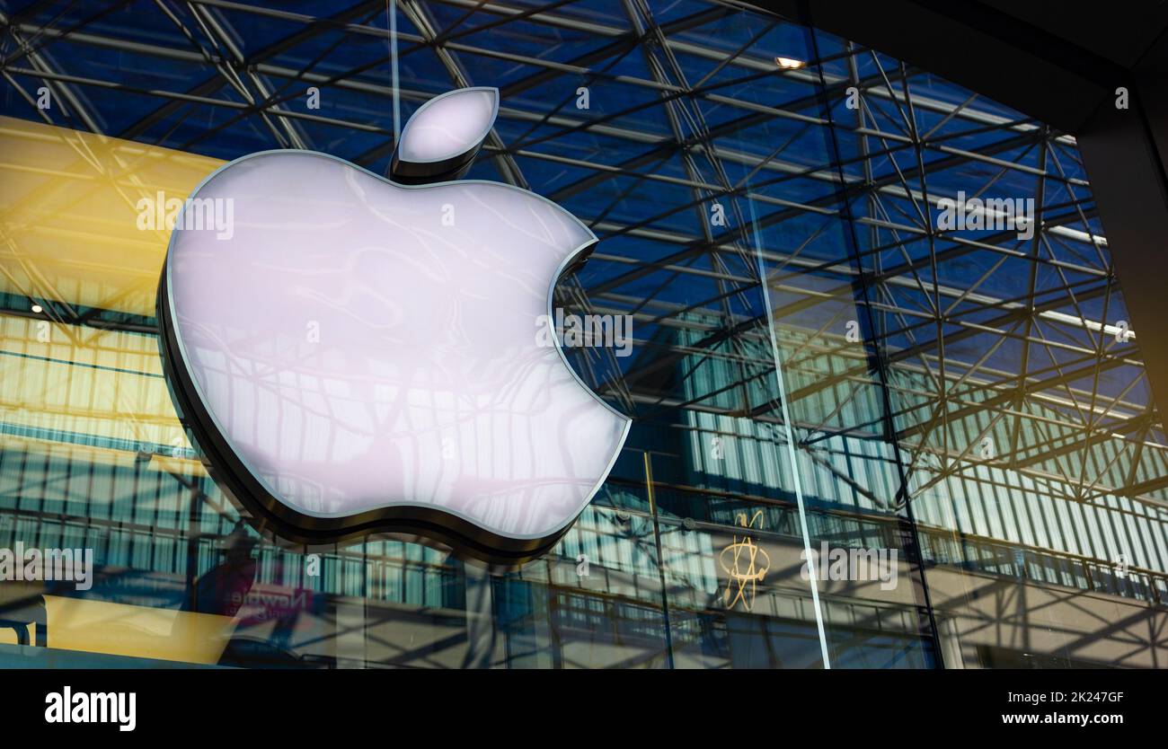 A black and white picture of the Apple sign outside of a store, in ...