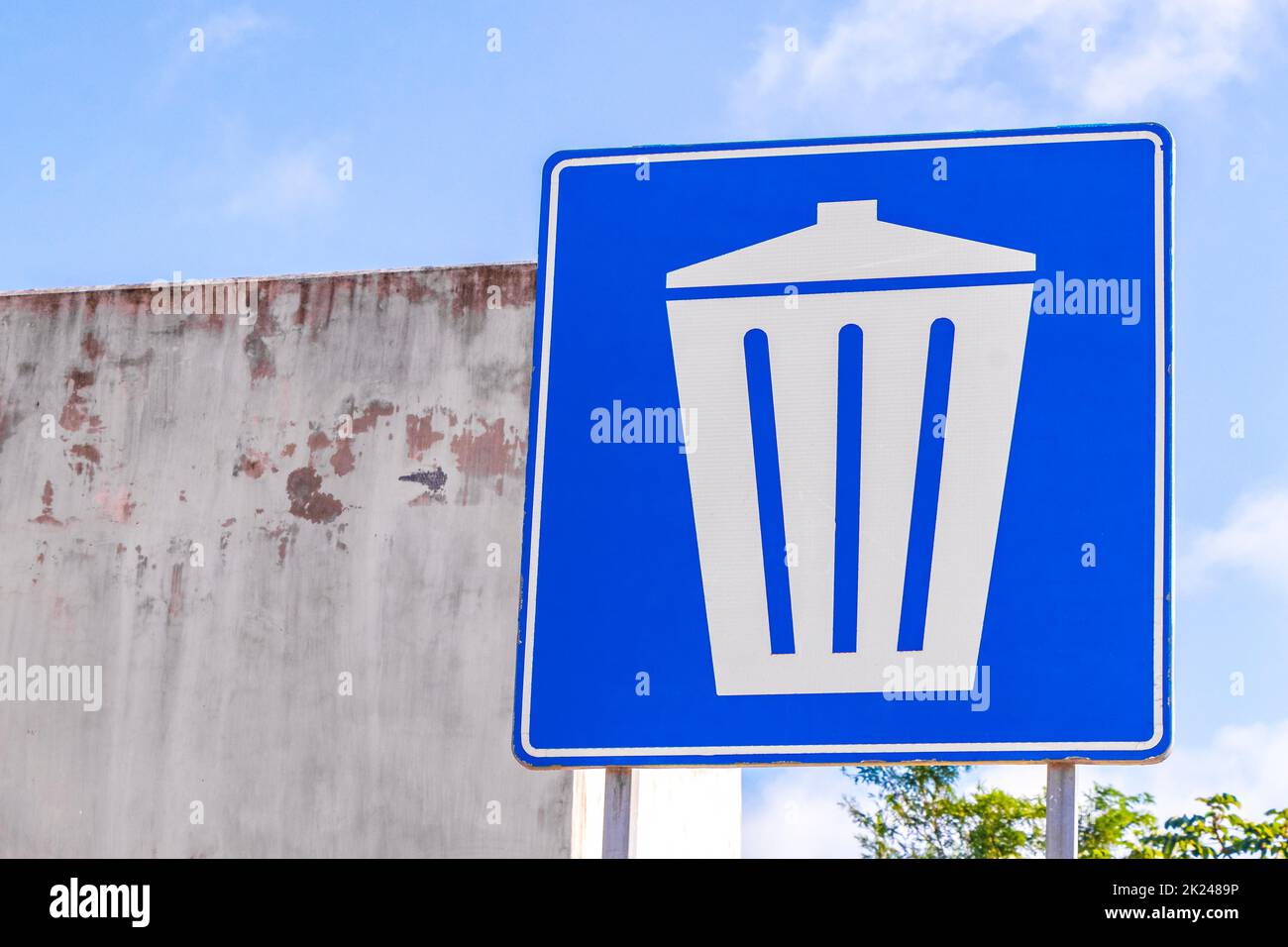 Blue garbage trash sign at the highway in the jungle and tropical ...
