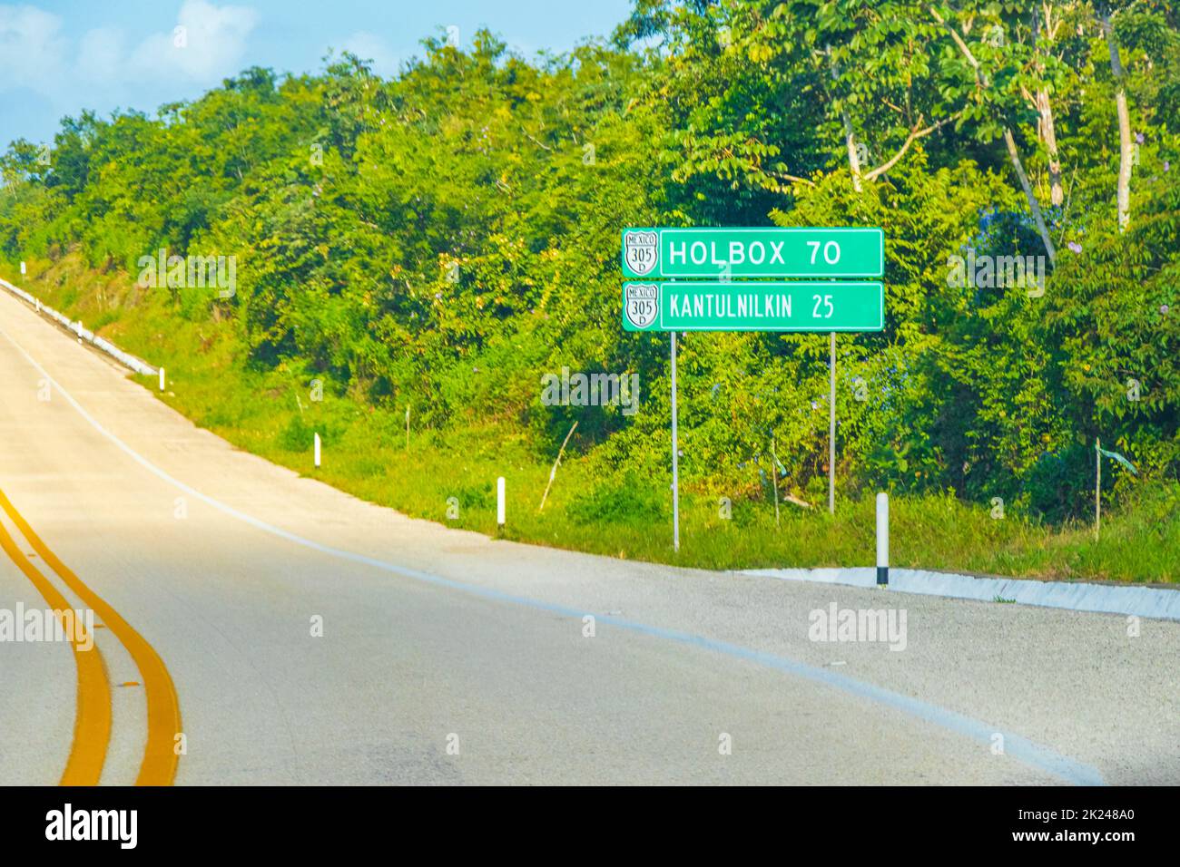 Road sign at the highway in the jungle and tropical nature of Playa del ...