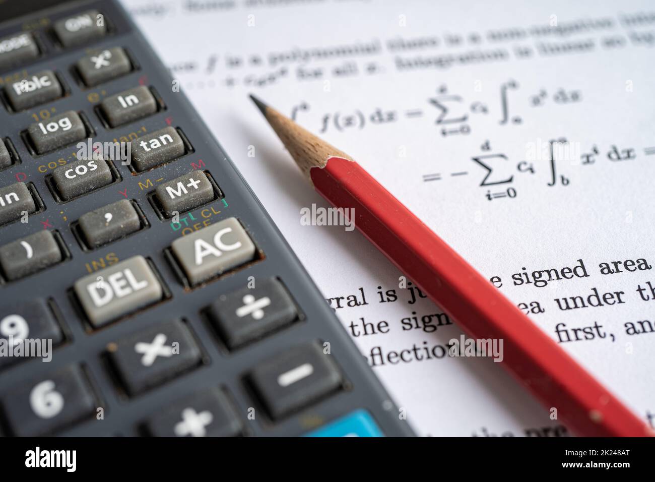 Pencil and calculator on mathematic formula exercise test paper in ...