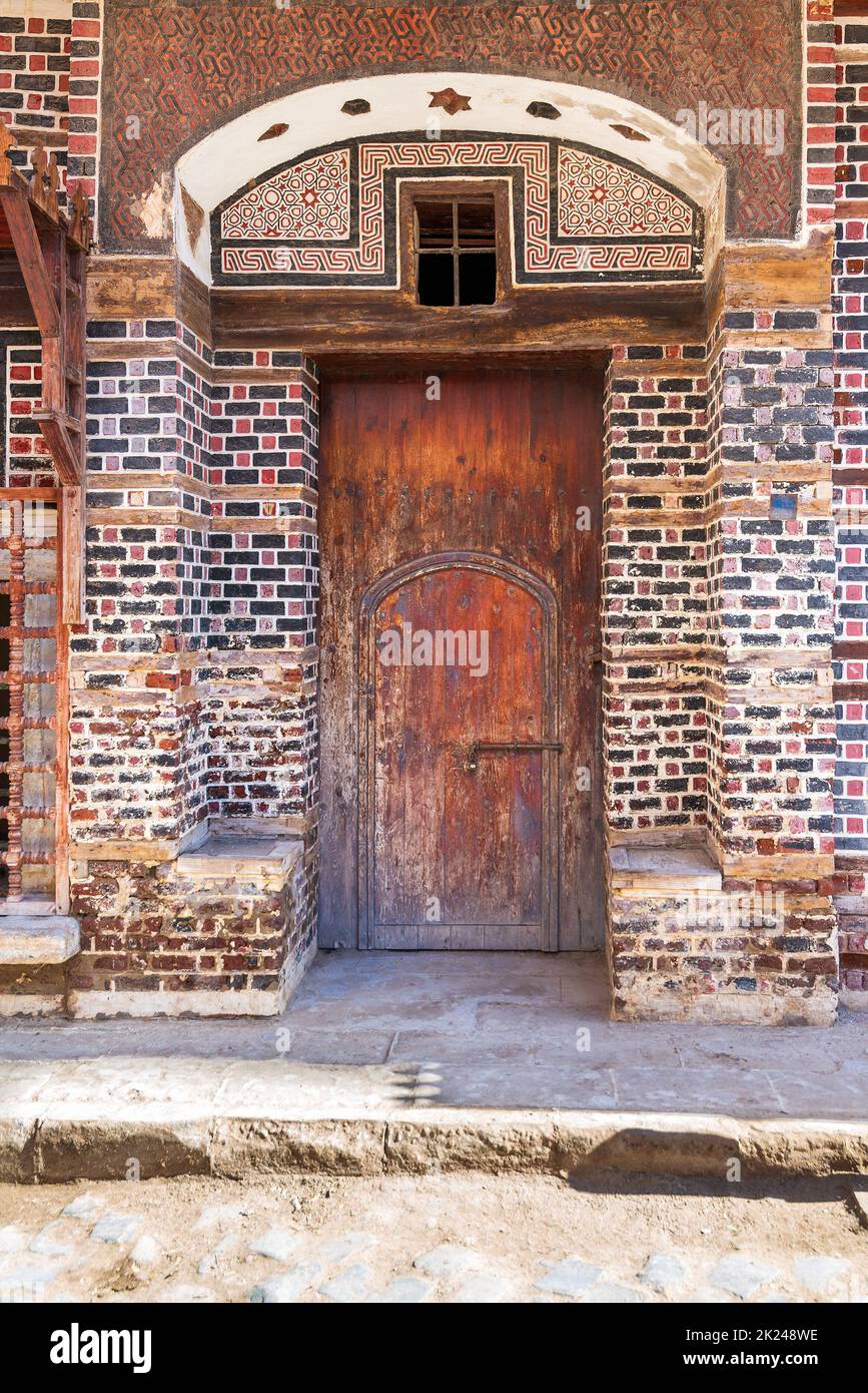 Wooden grunge decorated arched entrance gate with inner small wooden ...