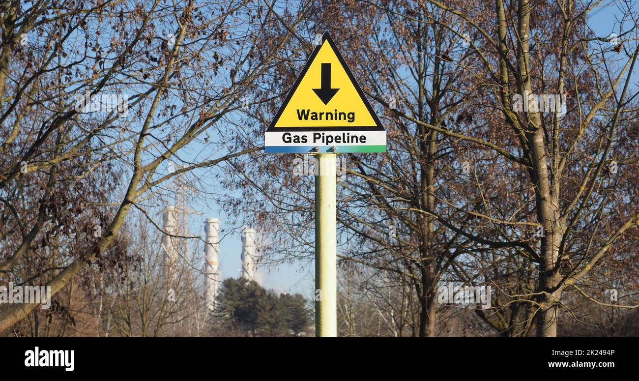 Warning gas pipeline sign and power station in the background Stock ...