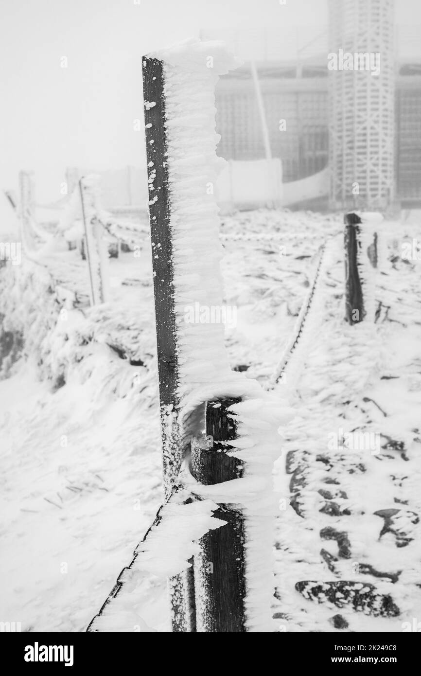 Chain fencing covered with ice and snow on a dangerous section of the ...