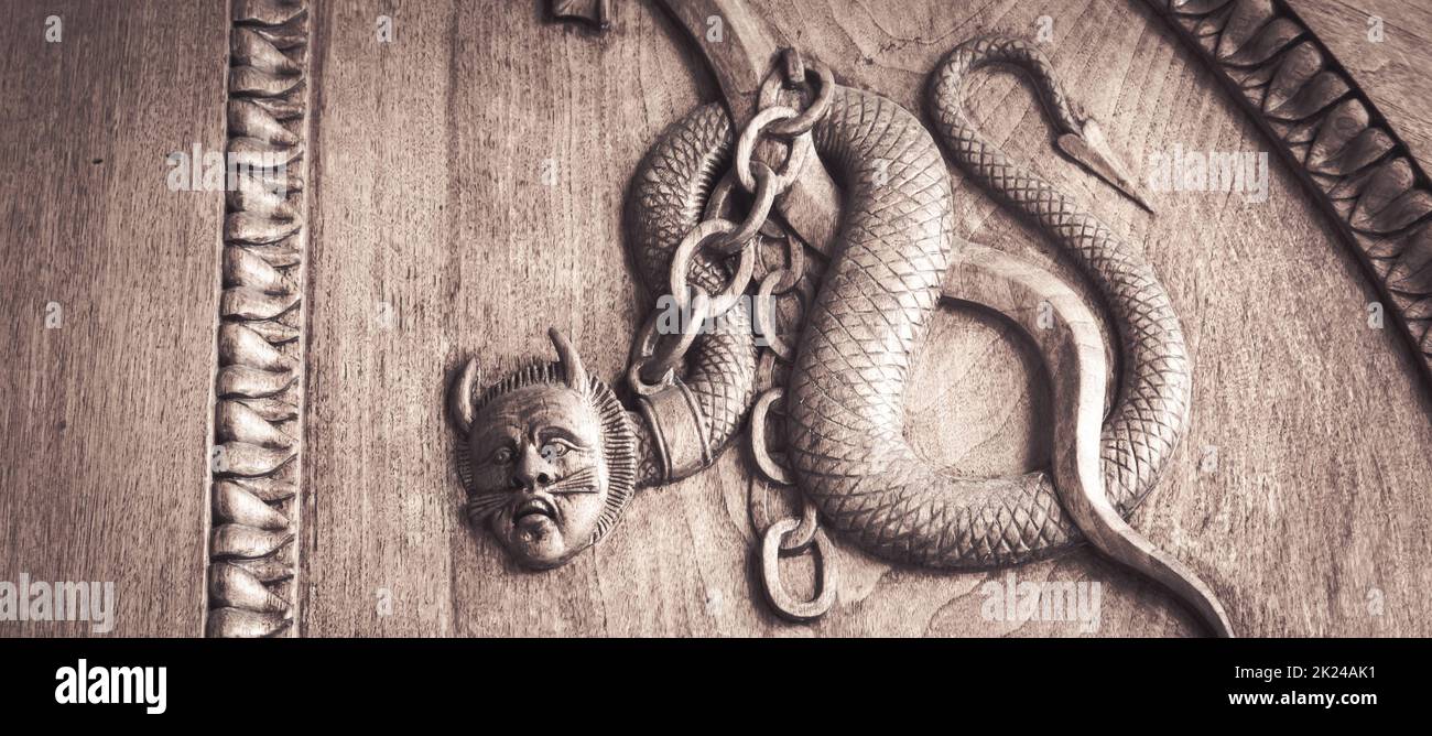 Devil snake symbol. Fantasy magic creature on an old door, 12th Century Abbey, Italy Stock Photo ...