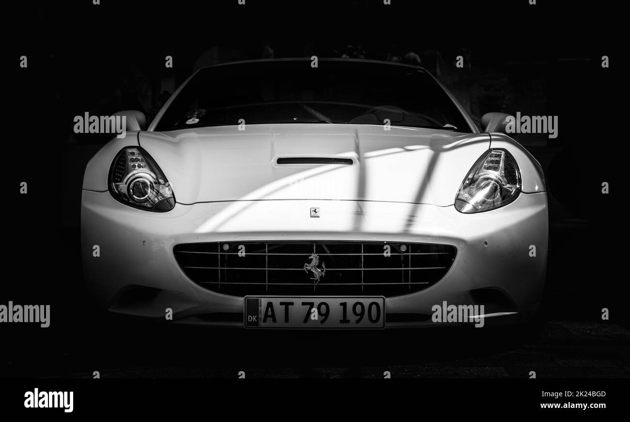 A black and white picture of the frontal view of a white Ferrari ...