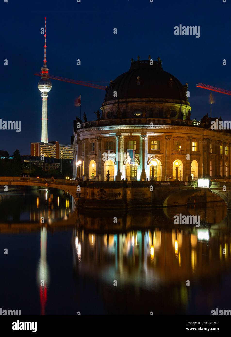 A picture of the Spree river at night, with the Bode Museum nearby and ...
