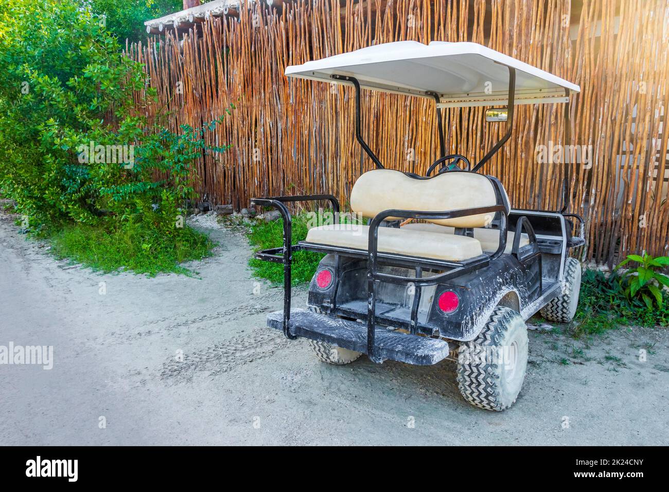 Golf cart buggy cars carts on muddy street in the village on Holbox ...