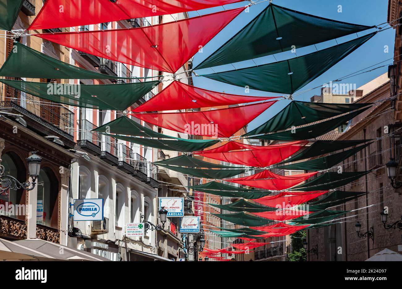 A picture of the colorful sun covers that decorate a street in Madrid ...
