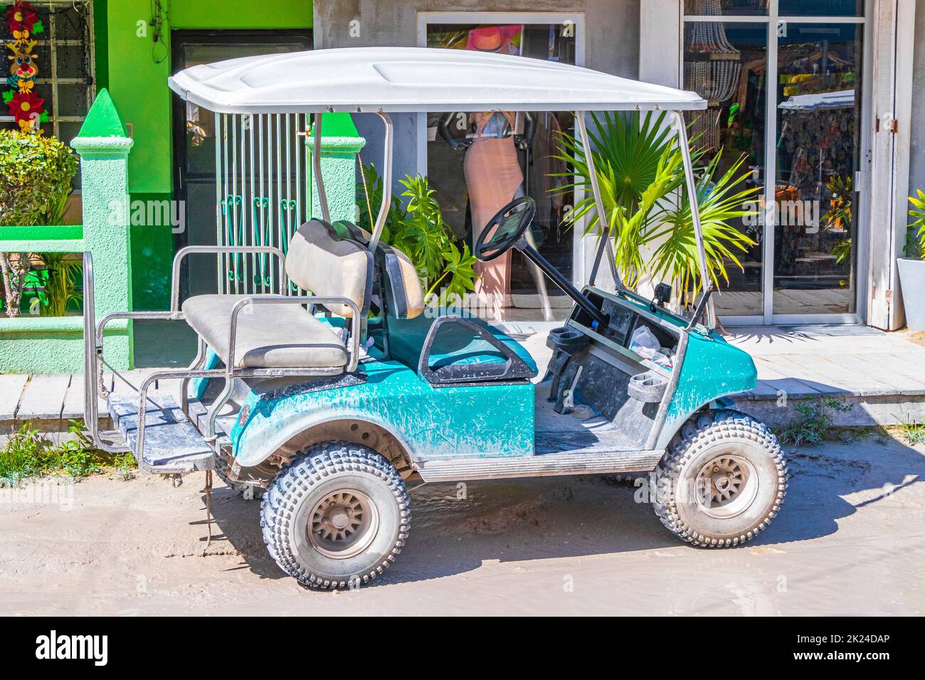 Golf cart buggy cars carts on muddy street in the village on Holbox ...