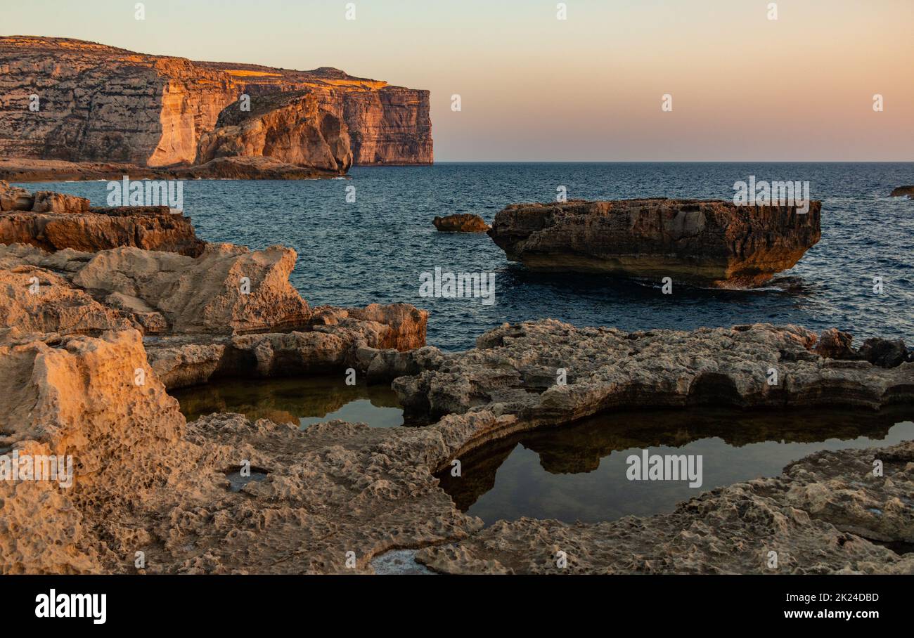 A picture of the rocky cliffs that dot the Gozo coast Stock Photo - Alamy